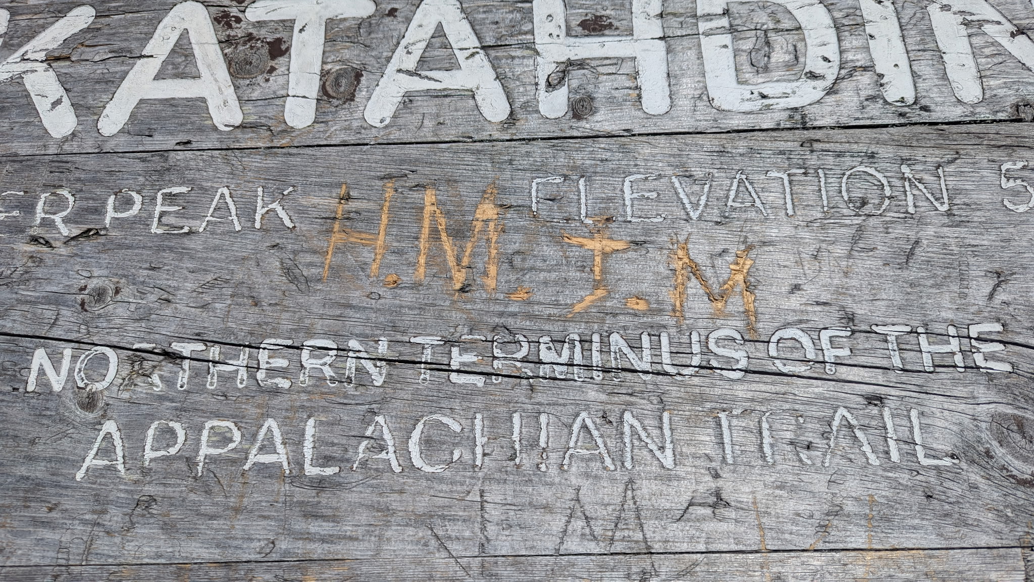 Someone carved initials into the sign at the summit of Katahdin ...